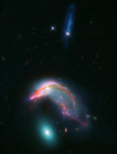 These Interacting Galaxies Resemble a Penguin Guarding an Egg