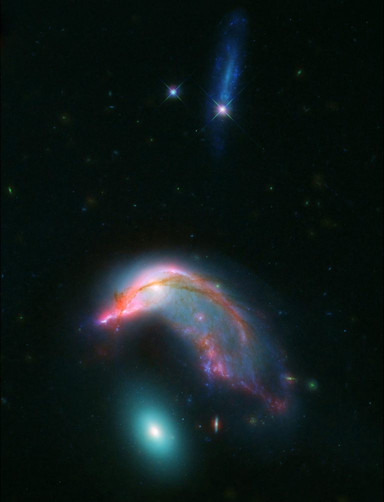 These Interacting Galaxies Resemble a Penguin Guarding an Egg