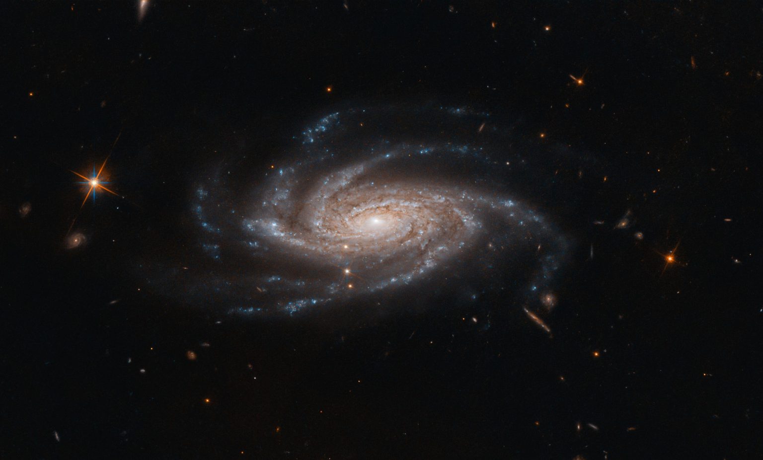 Hubble Space Telescope Spots Ghostly Spiral With Open Arms