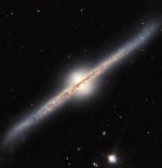 Hubble’s 23-Year Look at a Warped Spiral Galaxy Reveals Hidden Secrets